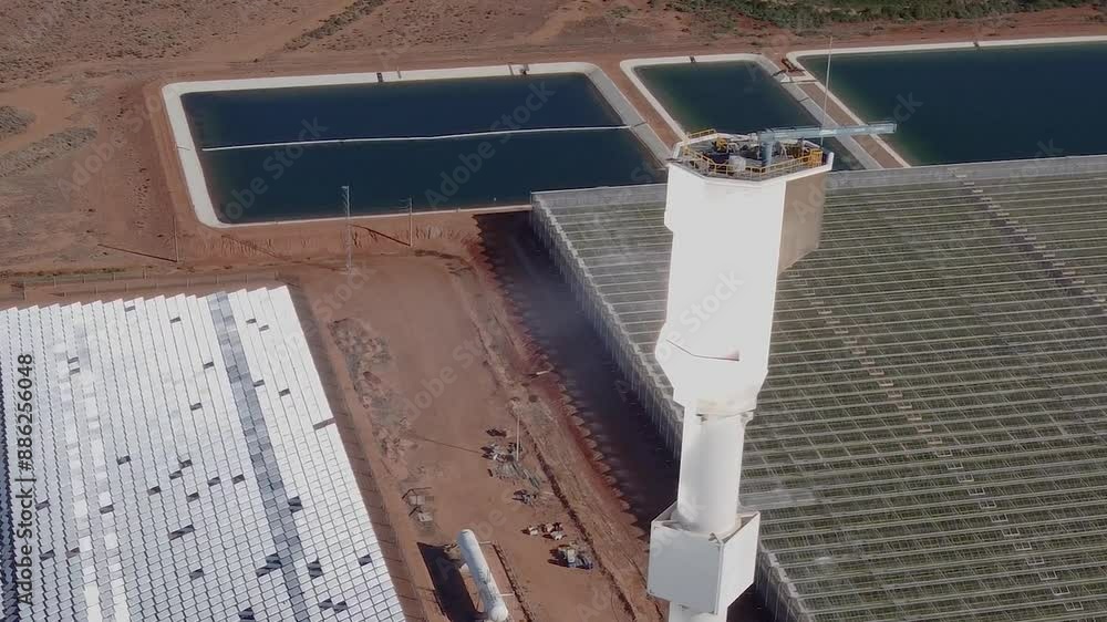 An aerial view of a solar thermal energy farm with thousands of mirrors ...