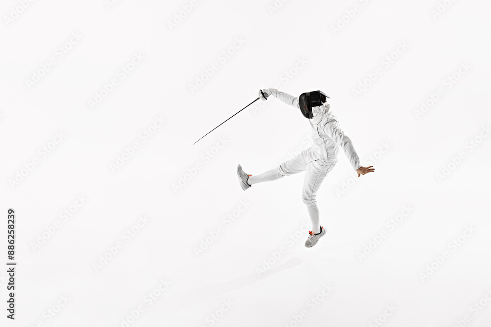 Fencer in complete white attire, including mask, depicted in mid-leap ...