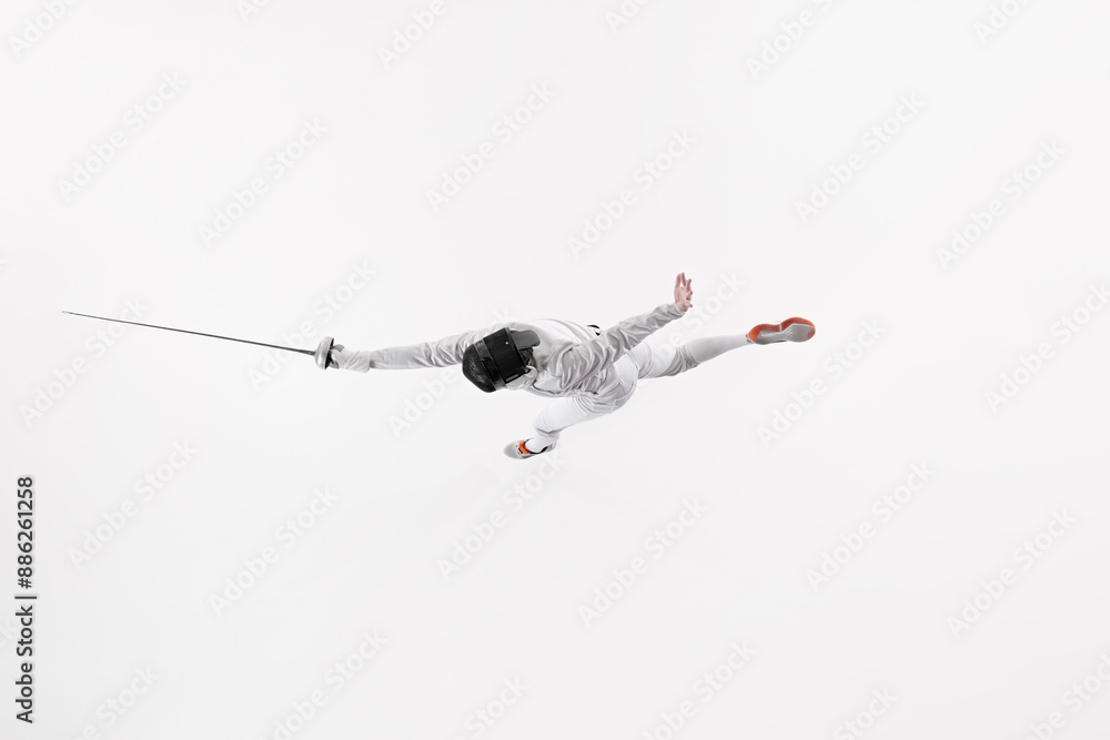 Overhead view of fencer with their rapier extended and one leg kicked ...