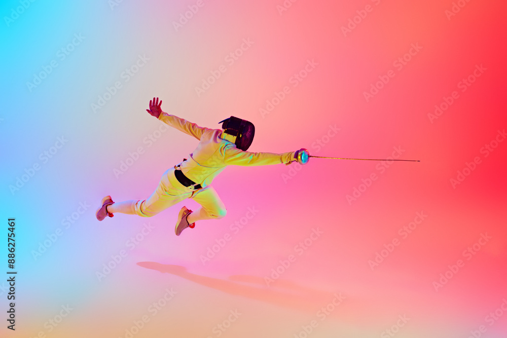 Fencer, outfitted in white suit and mask, strikes attacking pose with ...