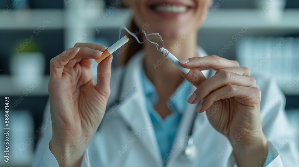 Extreme closeup of a female smiling doctor breaking a cigarette. Stop ...