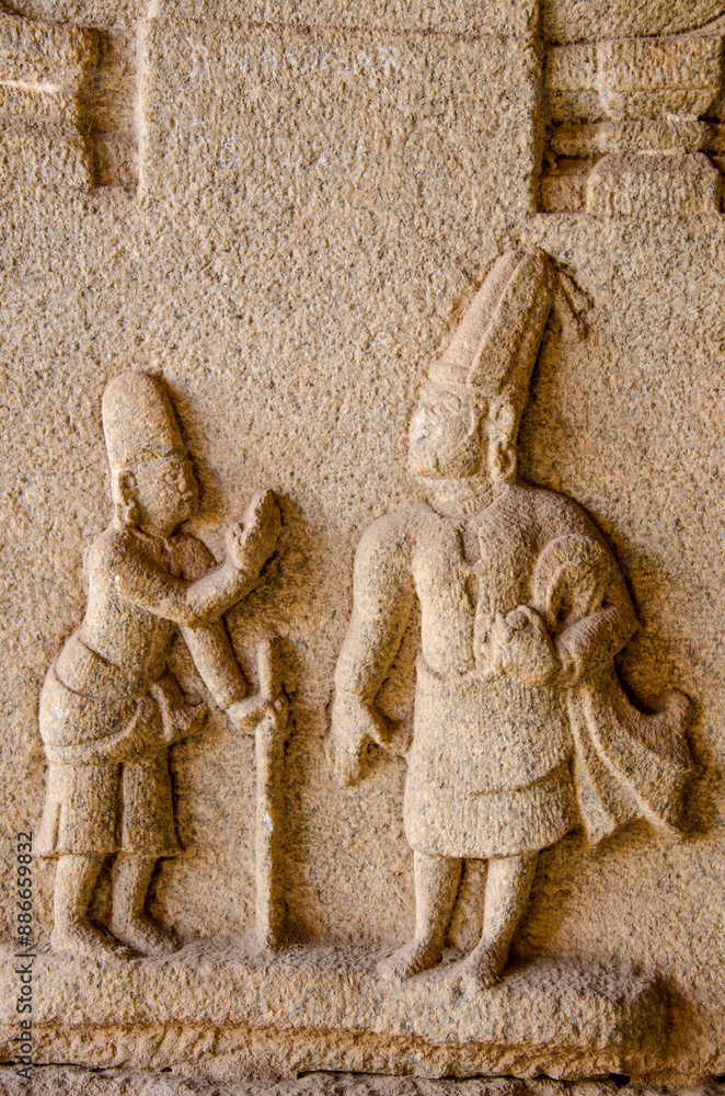 Stone bas-reliefs on the walls around the Temple in Hampi. Unesco World ...