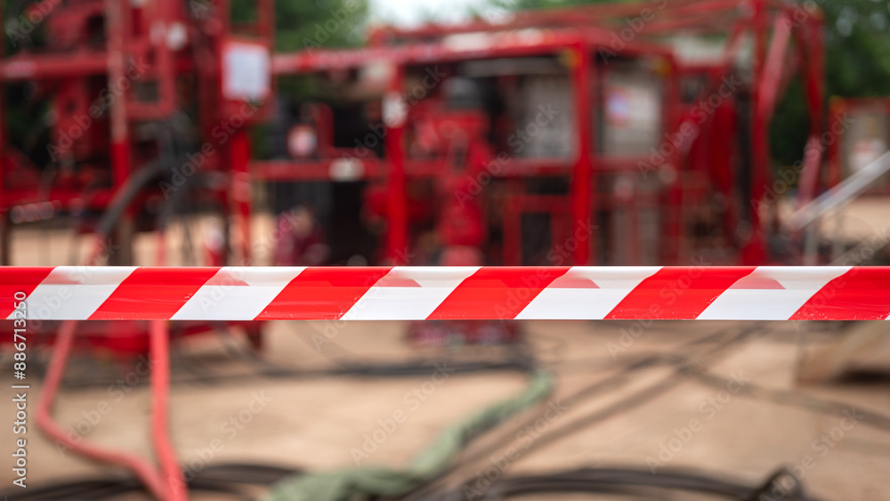 Caution "white-Red" tape stiped that using to barricade high risk area ...