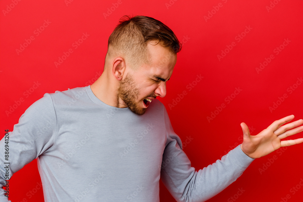 Angry angry young man in red with aggression against the. Phone mobile ...