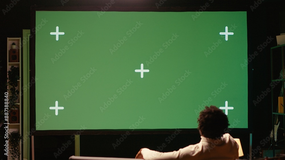 Man using green screen modern TV to watch news program broadcasting in ...