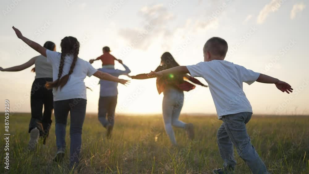 Family running together outdoors. Children and parents enjoying nature ...