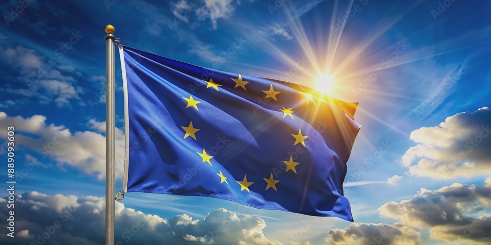 European Union flag proudly waves against a bright blue sky with golden ...