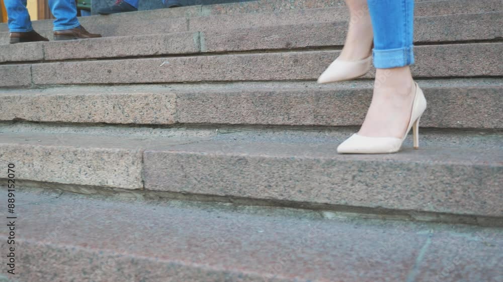 Female legs in jeans and trendy high heels shoes going down on stairs ...