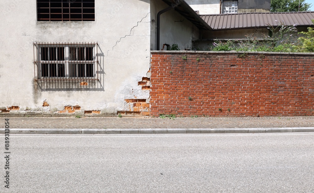 Old abandoned industrial building with peeled facade and surrounding ...