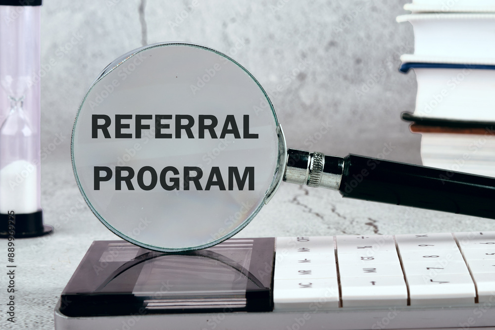 Business concept. Text REFERRAL PROGRAM appeared through a magnifying ...