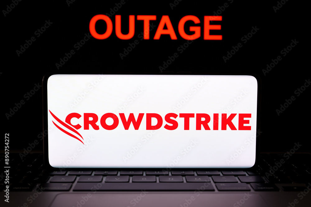 CrowdStrike logo seen on screen of smartphone and the word OUTAGE seen ...