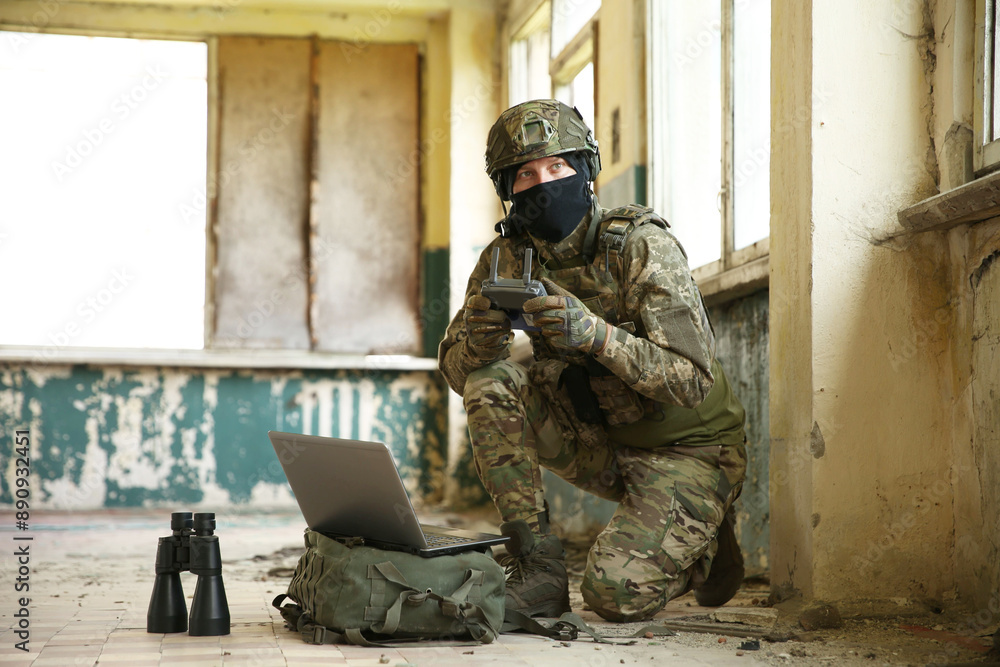 Military mission. Soldier in uniform using laptop and binoculars inside ...