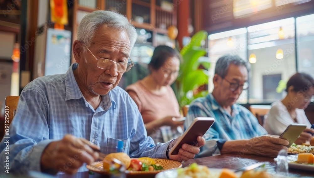 Older Asian men have vision problems and stare at their smartphones ...