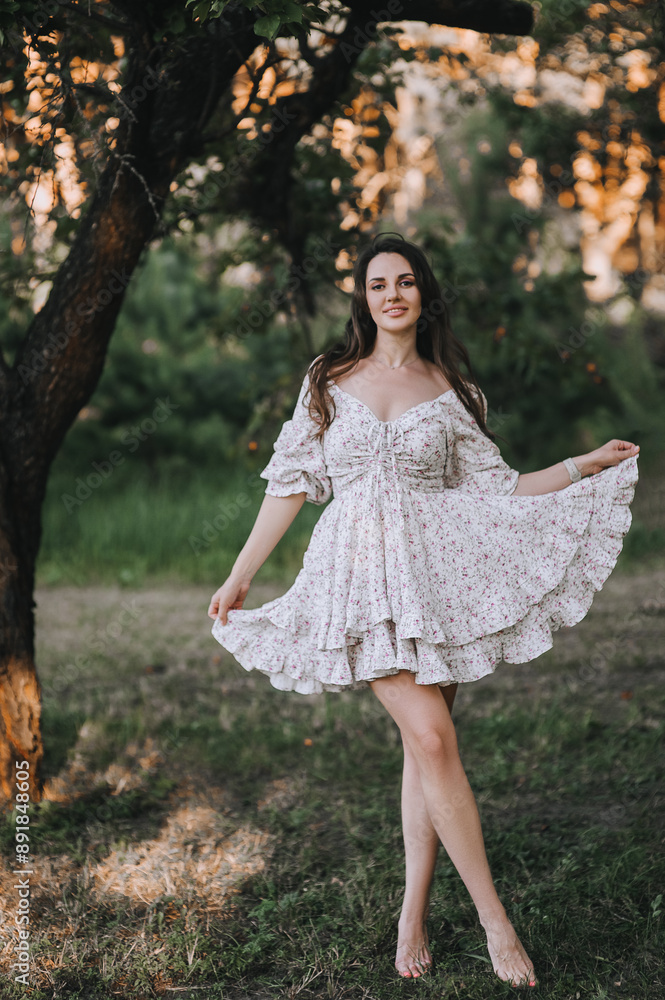 Beautiful young smiling happy barefoot brunette woman model in a summer ...