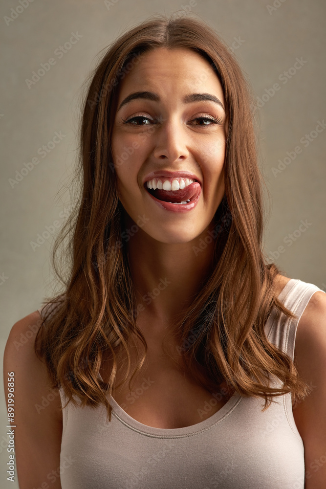 Happy, tongue out and portrait of woman in studio with smile for ...
