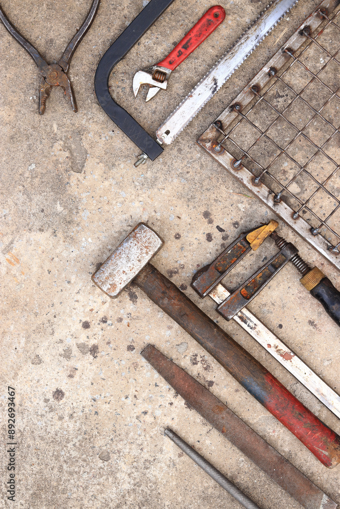 Old construction tools laid out on a concrete background, top view ...