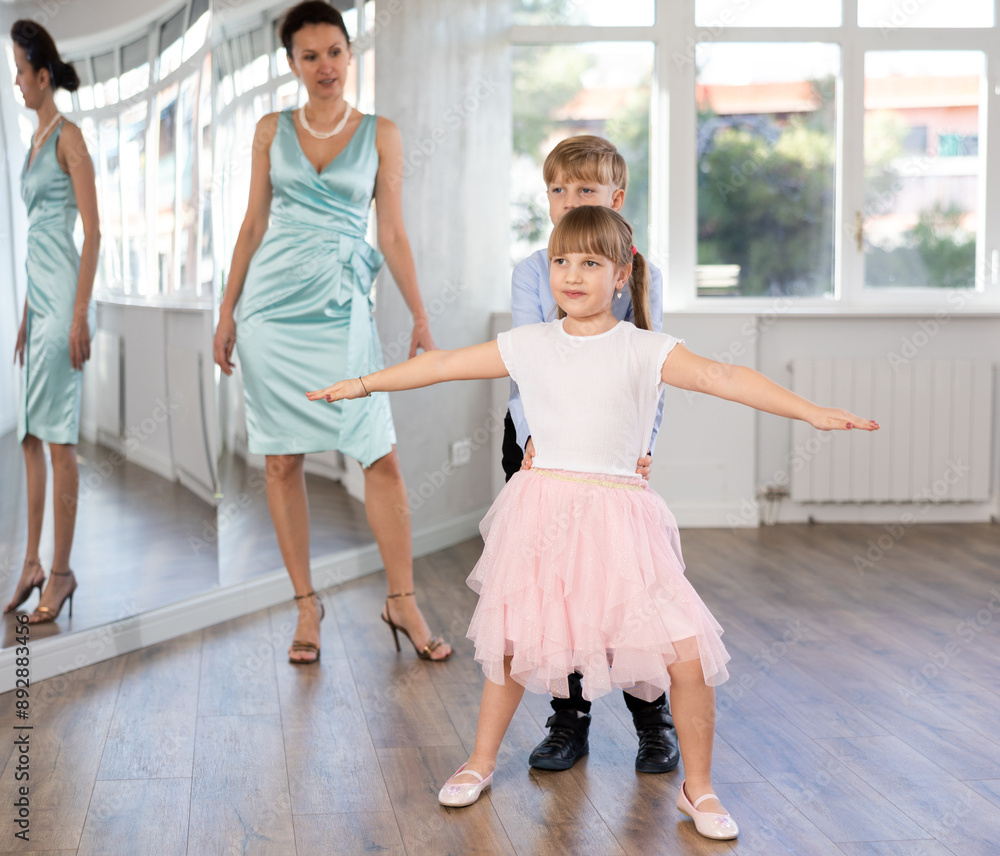 Positive dynamic preteen dance duo, boy and girl, refining slow foxtrot ...