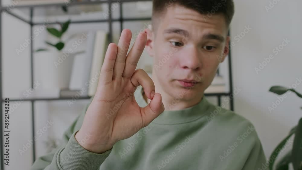 Medium close-up POV of deaf teenage Caucasian boy with hearing ...