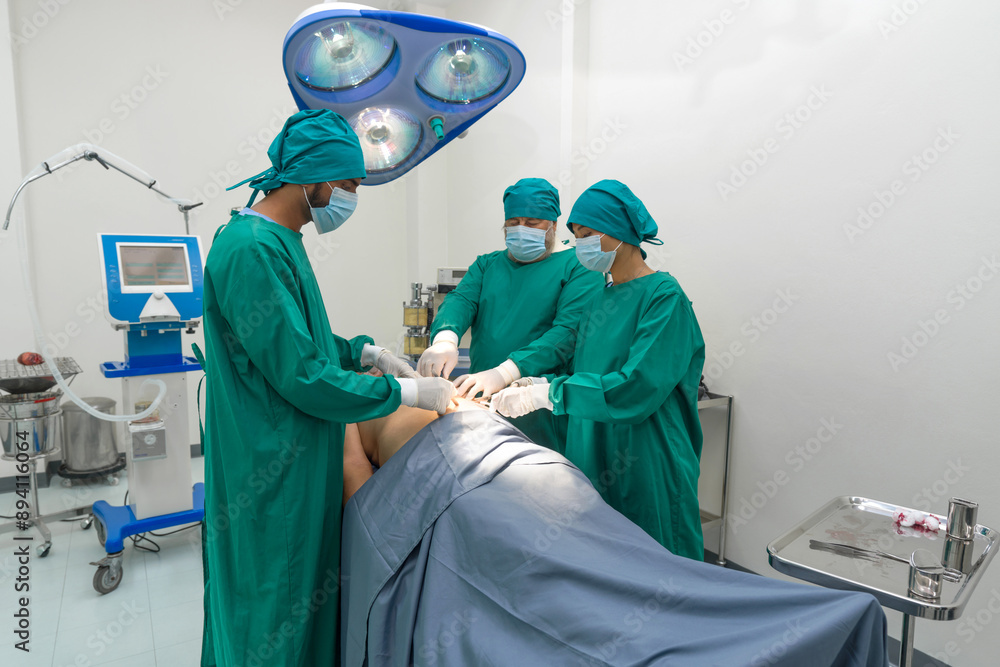 Group of surgeon and nurse in surgical green gown uniform performing ...