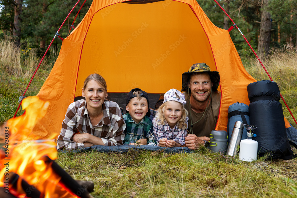 happy family with kids camping in the forest. laying and relaxing in ...