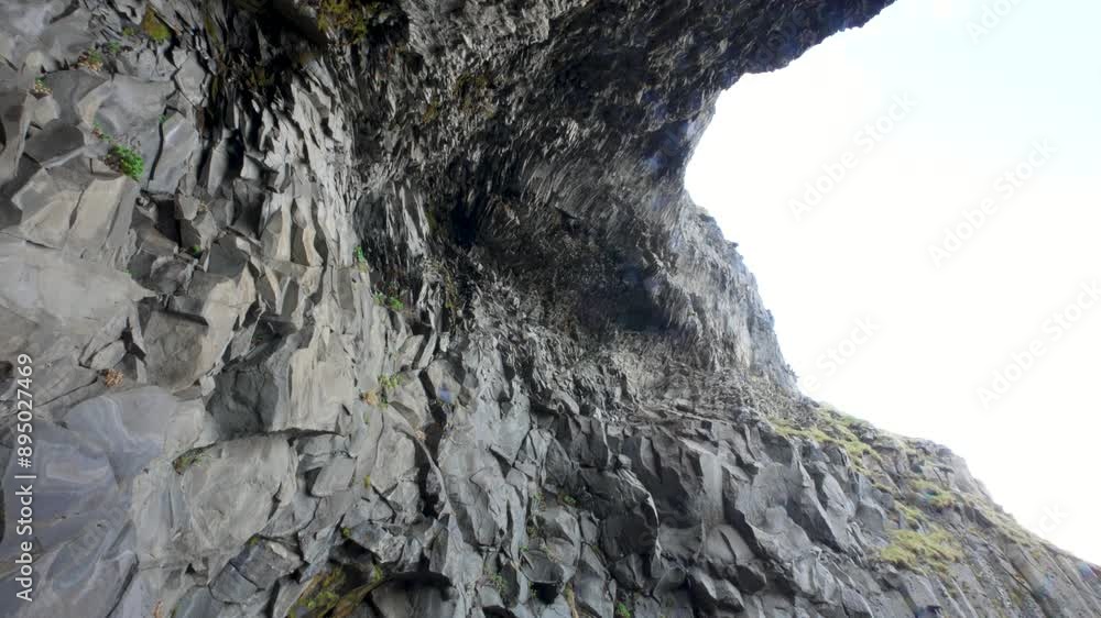 Basalt columns and sea cave with irregular shapes. Volcanic sand, Vik ...