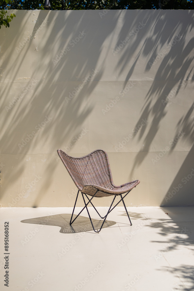 wicker stick cane bamboo chairs in front of a white wall and casting ...