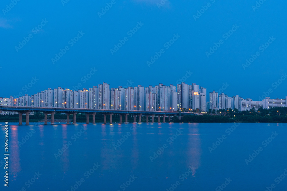 Night view of Olympic Bridge on Han River against apartments and Jamsil ...