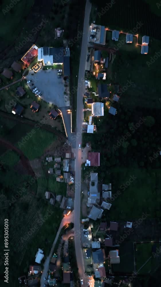 A stunning aerial night view of a small village showcasing illuminated ...