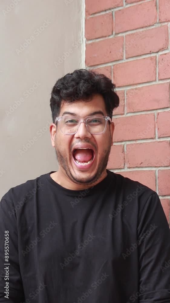 man doing jawline exercise by opening and expanding the mouth at ...
