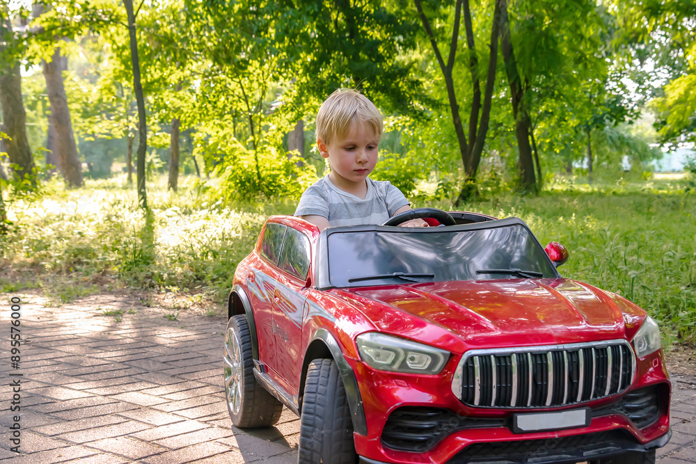 Cute blond little young toddler kid child boy driving,riding in ...