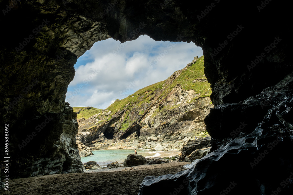Merlin's Cave and paddle in rock pools on the beach. Located below ...
