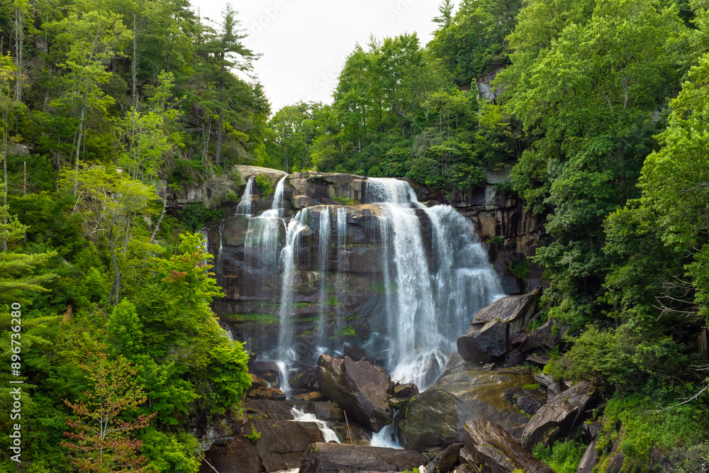 Whitewater Falls with falling down clear water from rocky boulders ...
