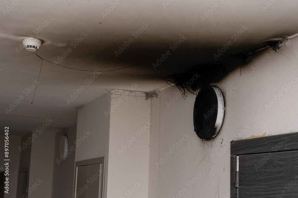 Burnt out LED lamp. A lampshade lamp on the wall after a fire ...