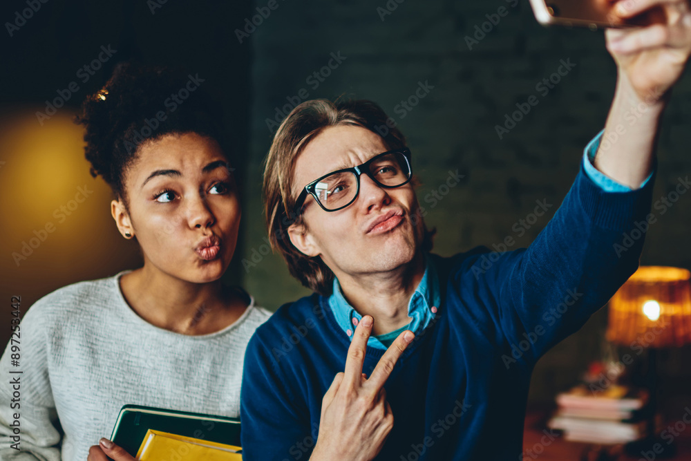 Young multiracial colleagues posing for common selfie on smartphone ...