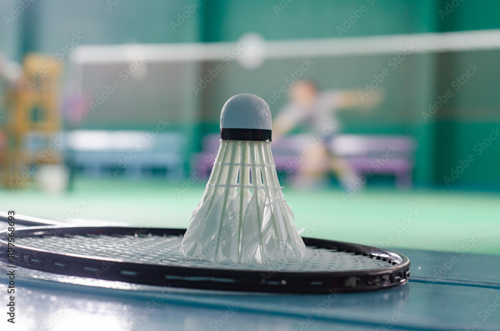 Badminton rackets and white cream badminton shuttlecocks after playing ...