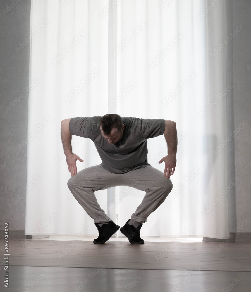 Dance in motion, pose of a man in hip-hop style clothes. Sports dancing ...