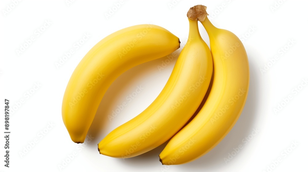 Three bananas are sitting on a white background. The bananas are yellow ...