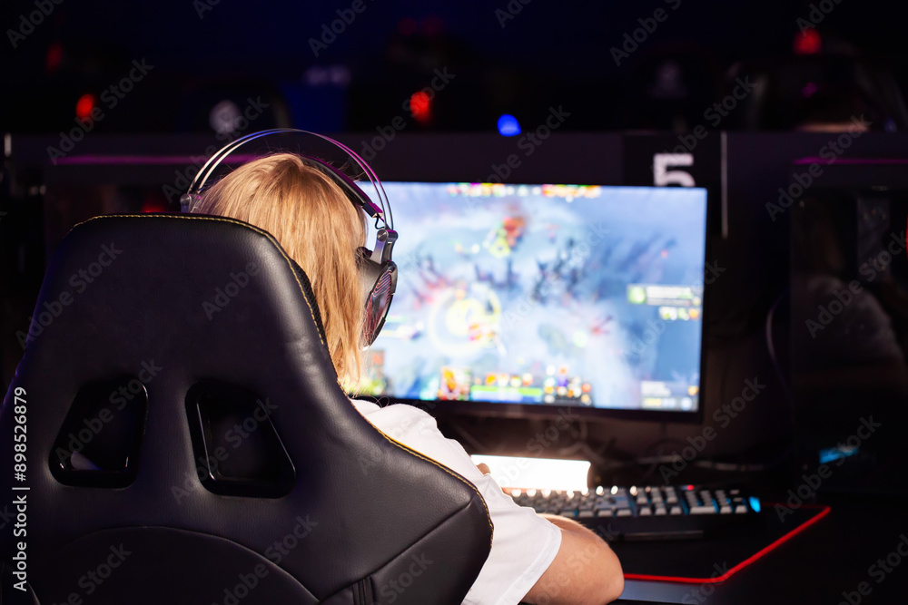 E-sport tournament Gamer in headset plays video game on PC Computer ...