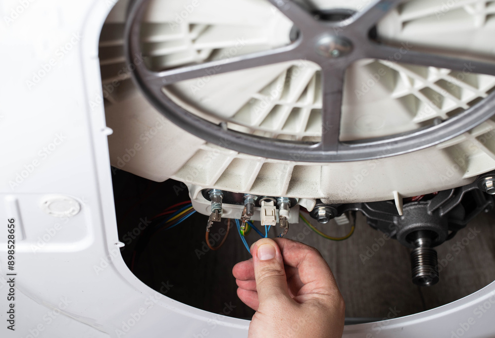 The hand of the master removes the electrical chips to remove the ...