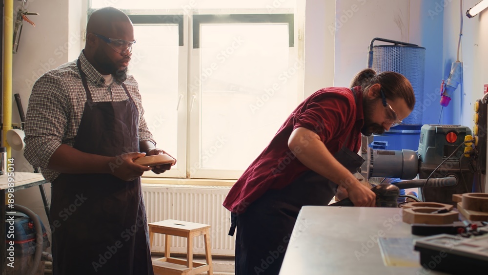 Carpenter making modifications on blueprint drawings, using angle ...