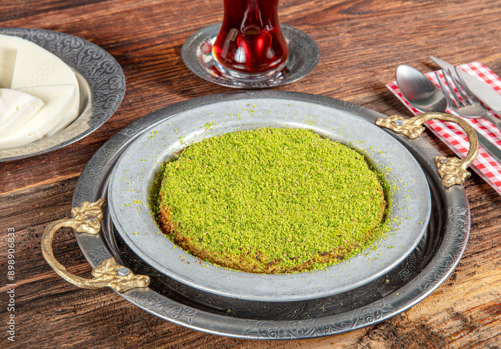Turkish dessert kunefe, kunafa, kadayif with pistachio powder and ...