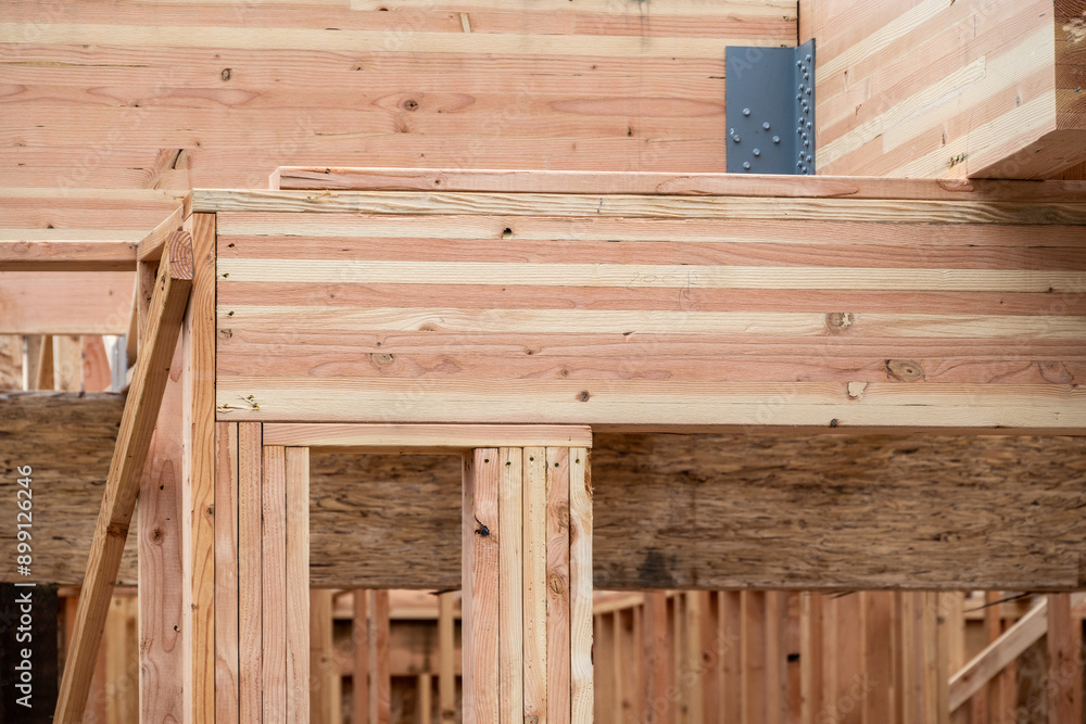 Closeup detail of new house construction, large glue laminate wood support beams and Parallel ...