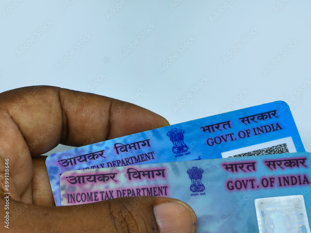 PAN identification ID card of India held in hand on white background ...