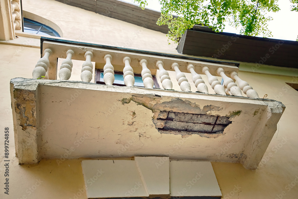 Balcony damage with visible cracks in concrete floor structure, falling ...