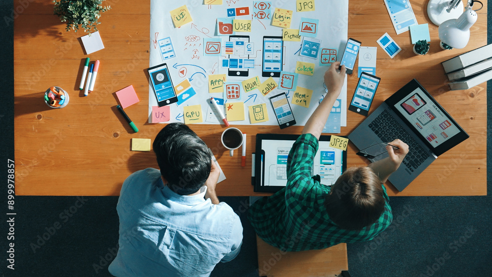 Top view of smart manager working together to develop Ux Ui design for mobile interface ...