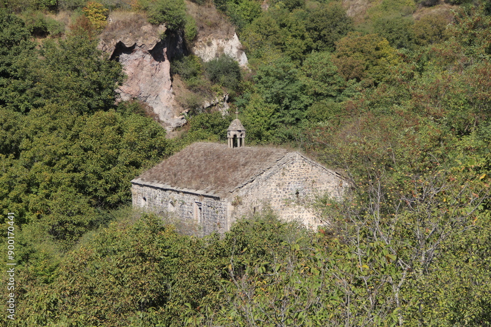 The small stone church has a simple design with a rectangular nave and ...