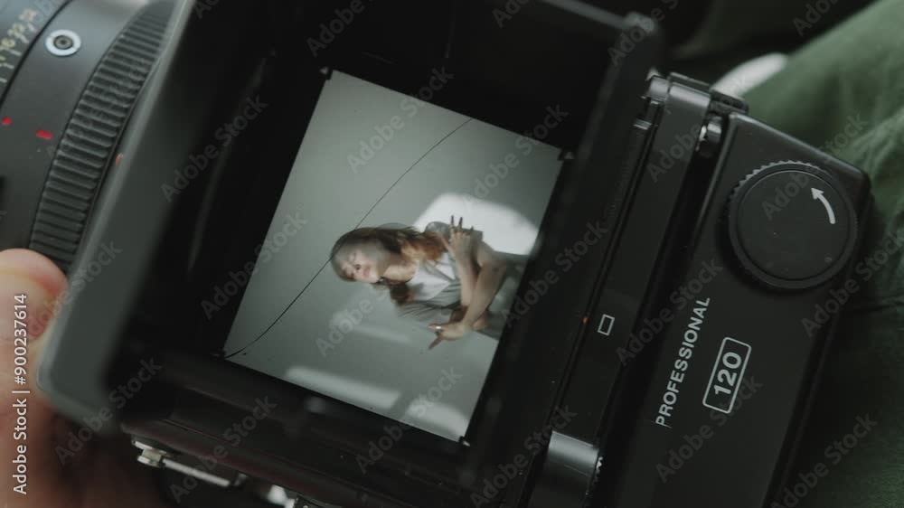 Hands of unrecognizable photographer reviewing photos of attractive ...