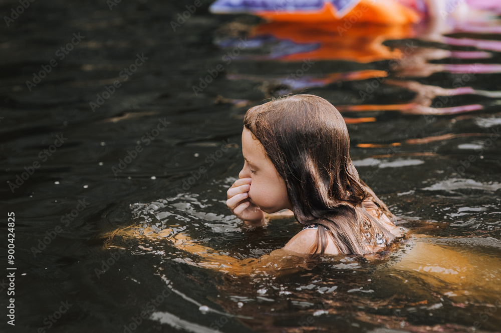 Little girl, child diving into water, emerging swimming from sea ...