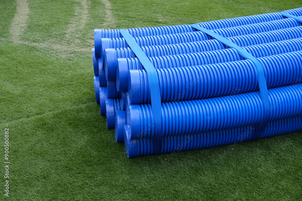 Blue plastic corrugated tubing, synthetic pipes used in construction ...