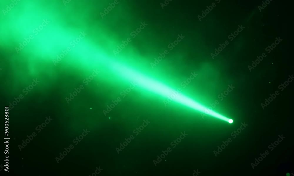 Green Laser Beam Cutting Through Smoke: A dramatic close-up of a ...